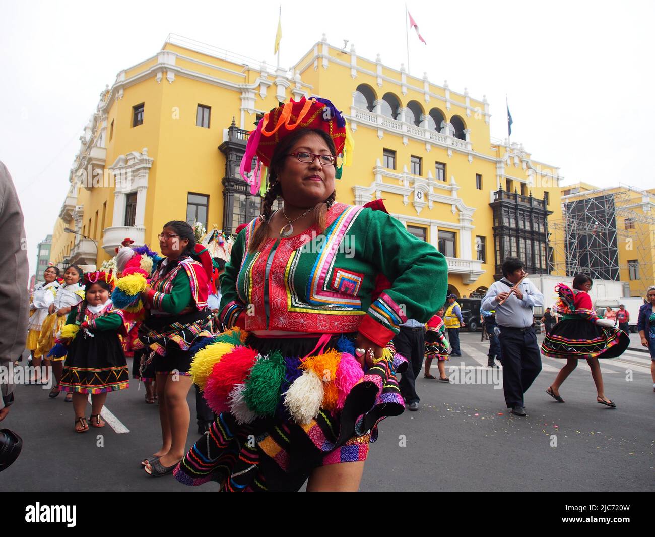 Women in typical costumes dancing in the procession. Hundreds of people ...
