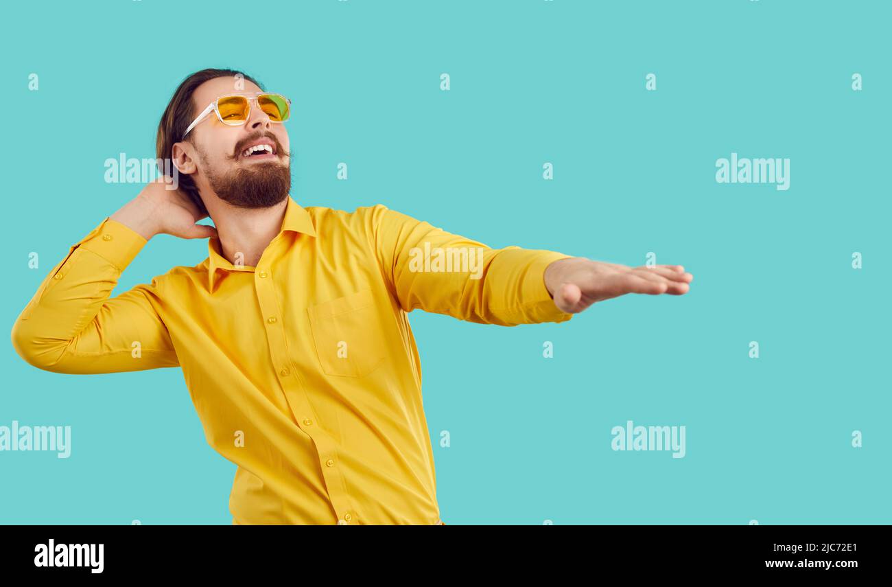 Cool cheerful young man funny rejoicing and having fun isolated on ...