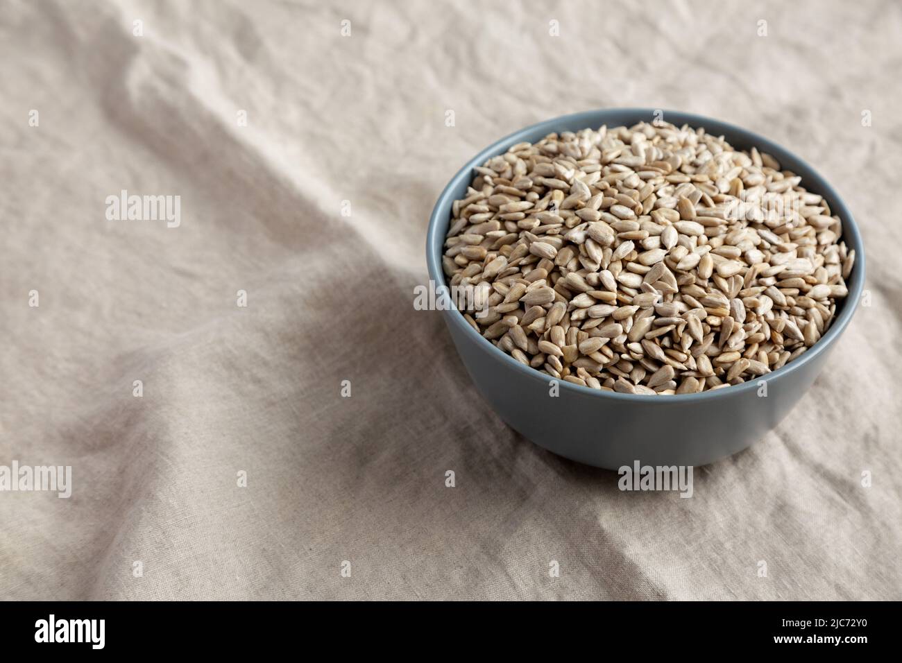Raw Organic Sunflower Seed Kernels in a Blue Bowl, side view. Space for ...