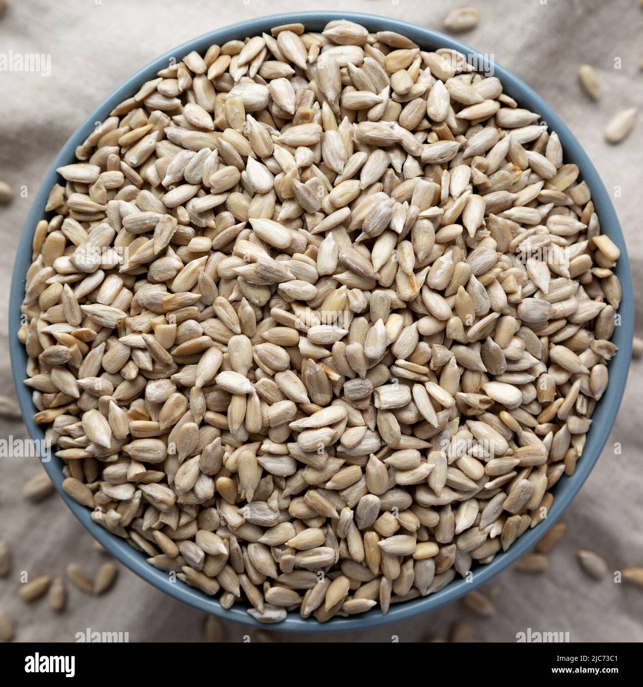 Raw Organic Sunflower Seed Kernels in a Blue Bowl, top view. Flat lay ...