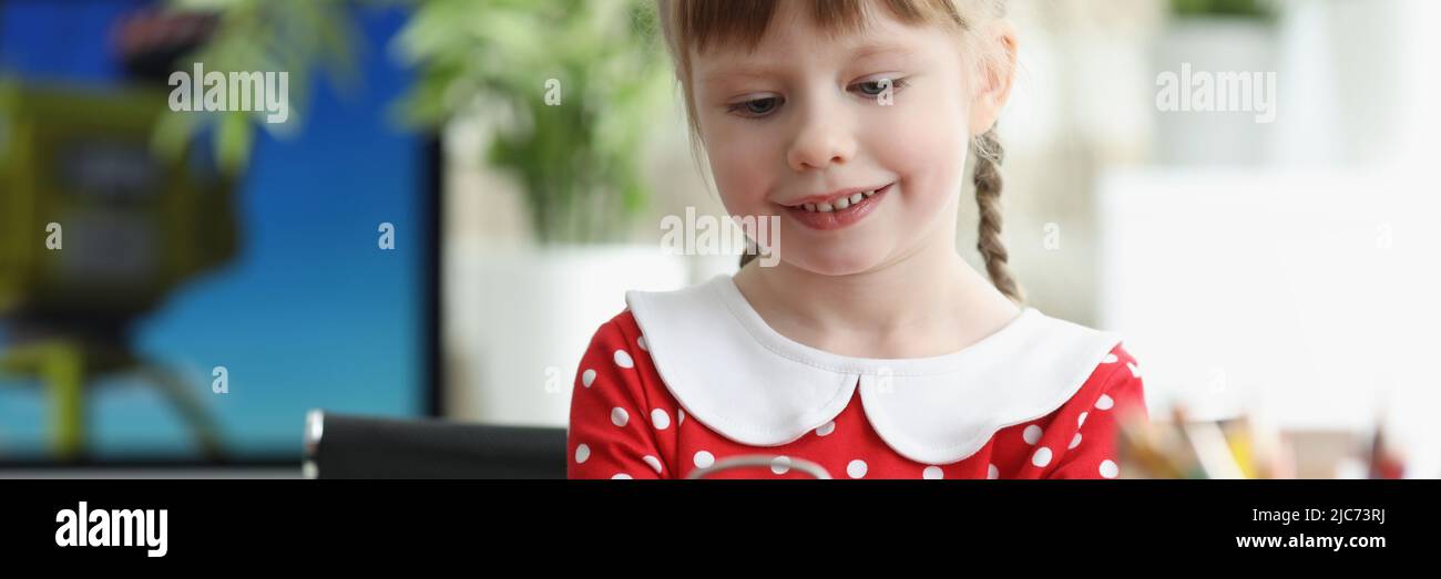 Little girl learning how to understand time and playing with red ...