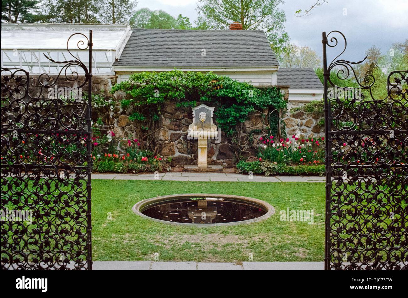 A fountain, pool and gate to garden at the Stevens-Coolidge house and ...