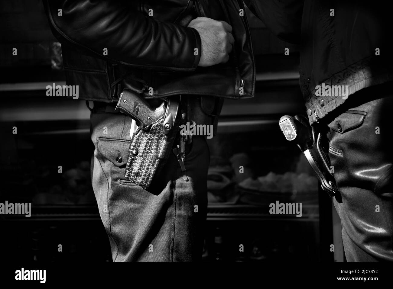 Two armed police officer wait in line to purchase cups of coffee in a ...