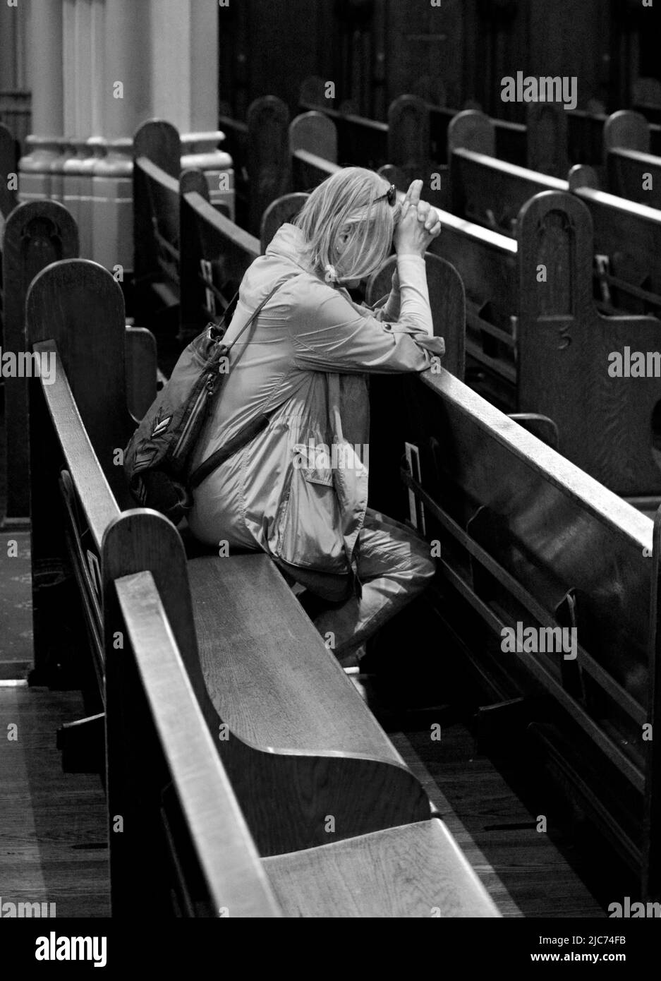 Praying alone catholic church hi-res stock photography and images - Alamy
