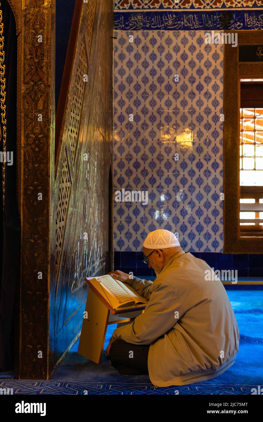 Elder muslim man reading Quran in the mosque. Islamic background photo ...
