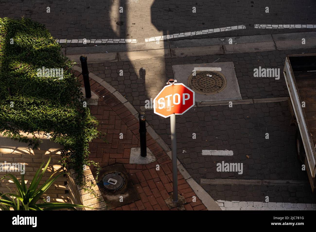 Red and white stop sign on an empty road Stock Photo - Alamy