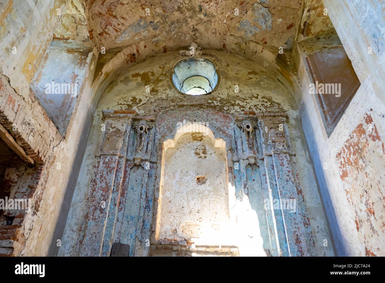 Interior of an ancient abandoned and dilapidated temple. Bottom up view ...