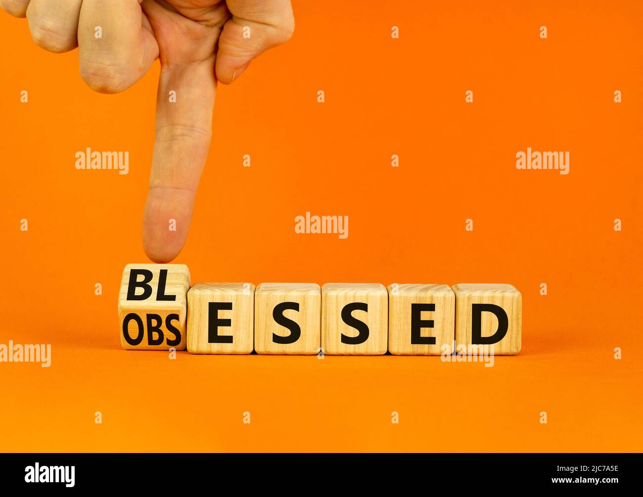 Blessed or obsessed symbol. Businessman turns wooden cubes and changes ...