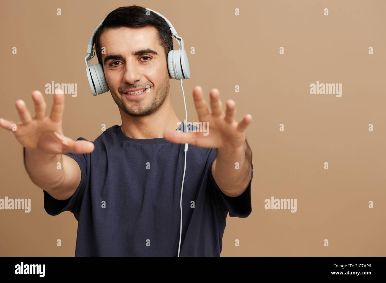 Cheerful man wearing white headphones posing music entertainment ...