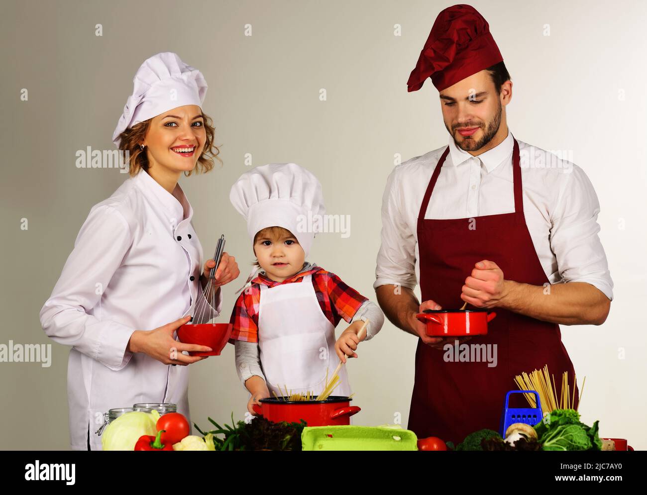 Happy parents teach little son cooking. Family with small child boy ...