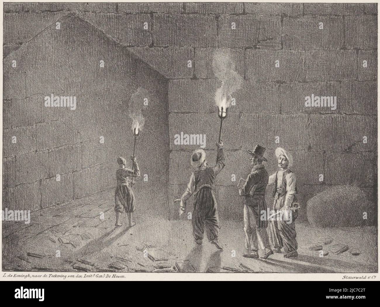 Four men are walking down a dark corridor. Two of them are carrying ...