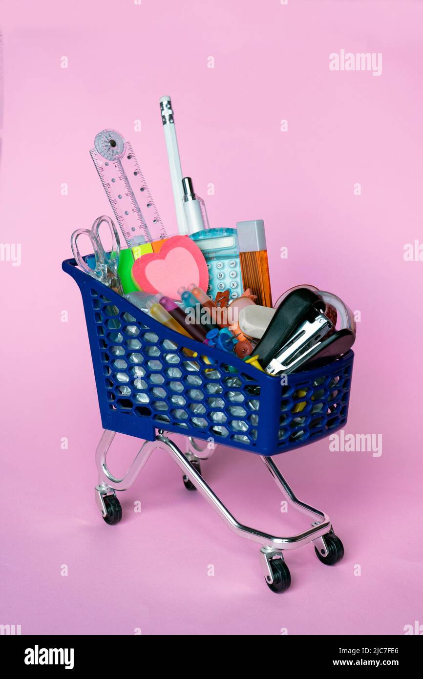 Mini grocery cart with stationery. Selective focus .Back to school ...