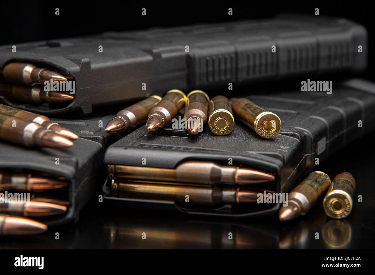 Bullet isolated on black background with reflexion. Rifle bullets close ...