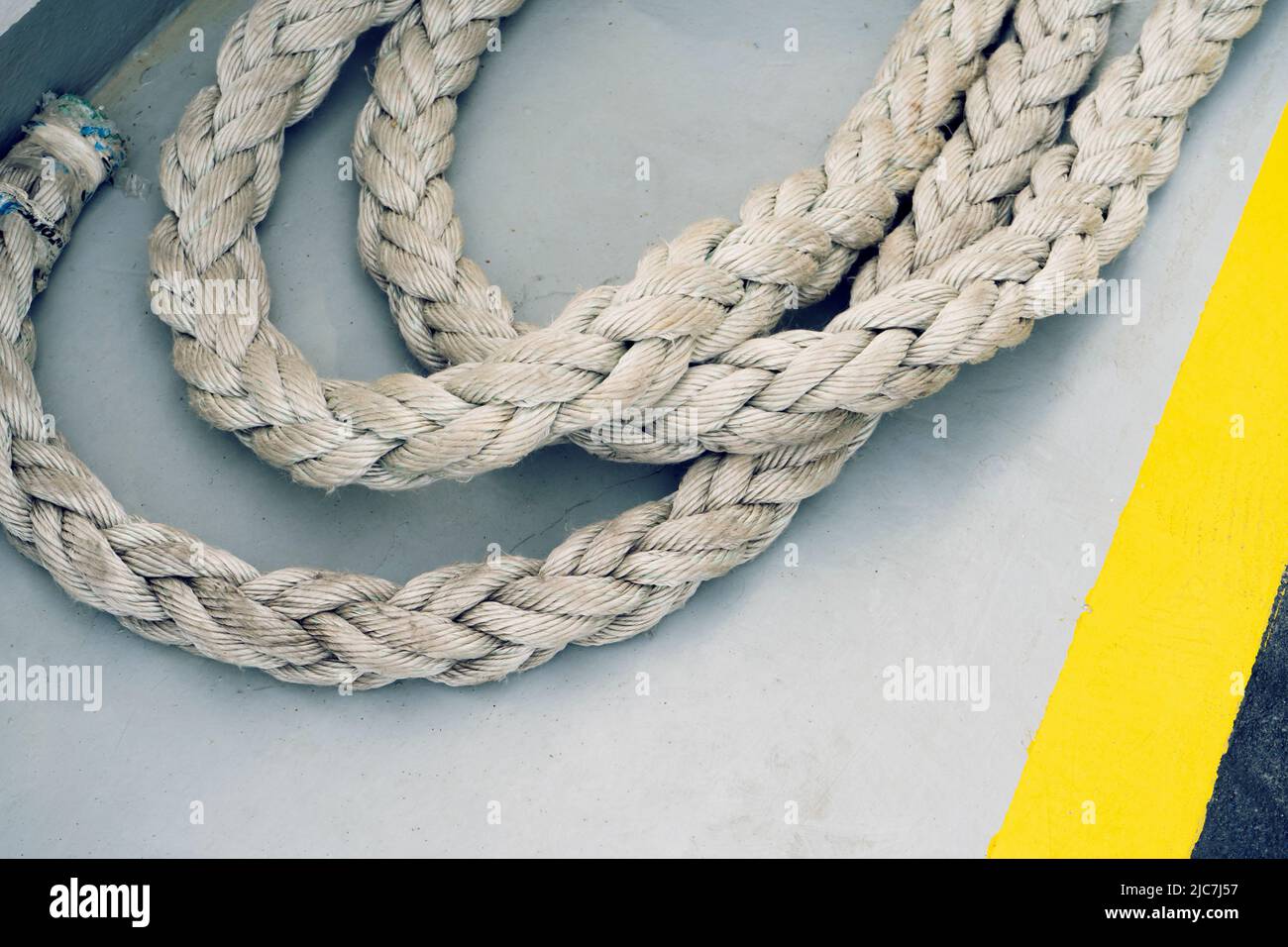Nautical rope on boat the grey floor. Close up. Nautical detail Stock ...