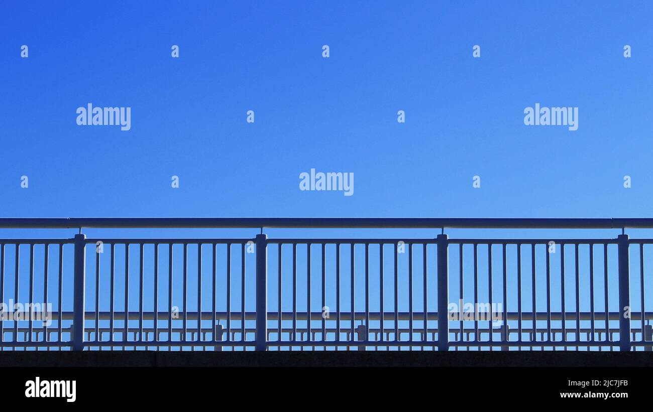 Sunny blue clear sky and white painted iron fence Stock Photo - Alamy