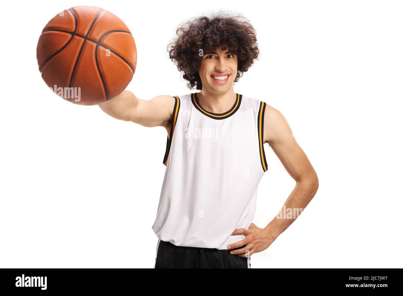 Basketball player holding a ball and smiling isolated on white ...