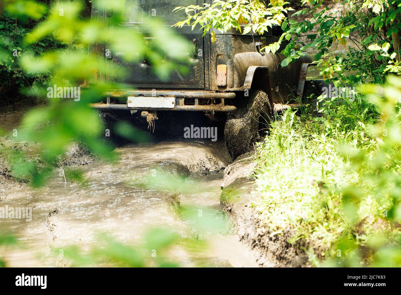 Back view of green russian off-road utility vehicle UAZ Hunter going up ...