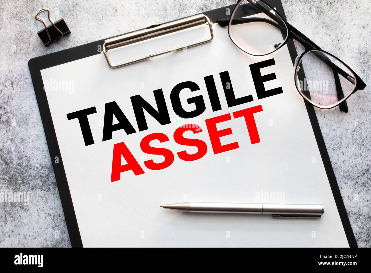 Tangible Asset text written on a notebook with pencils Stock Photo - Alamy