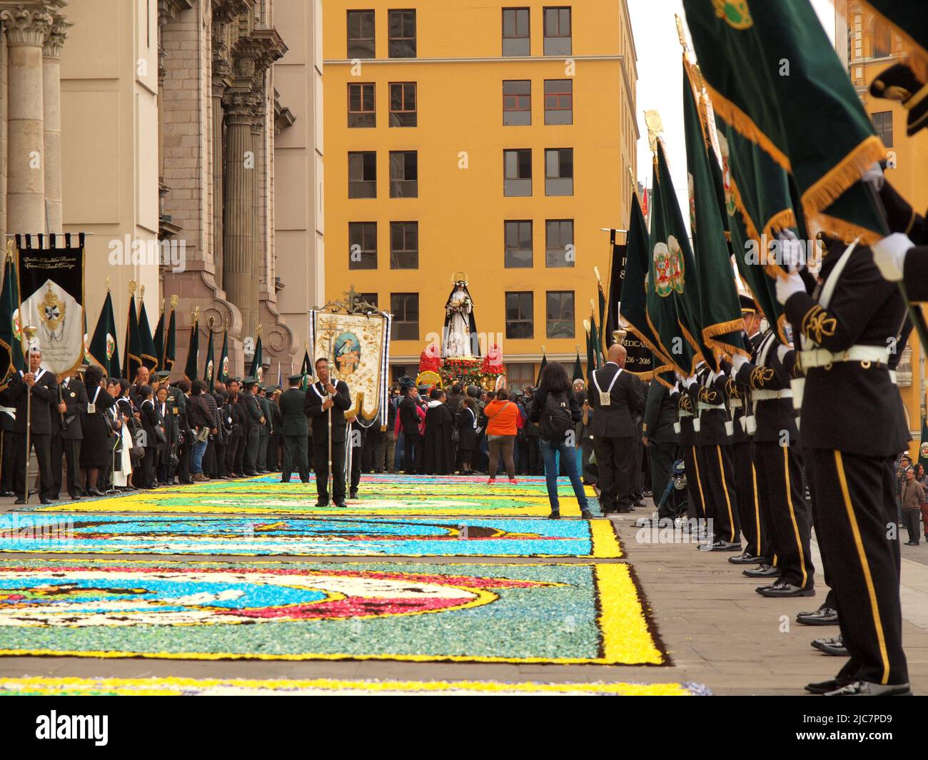 Devotees, escorted by police officers, carrying the religious litter of ...