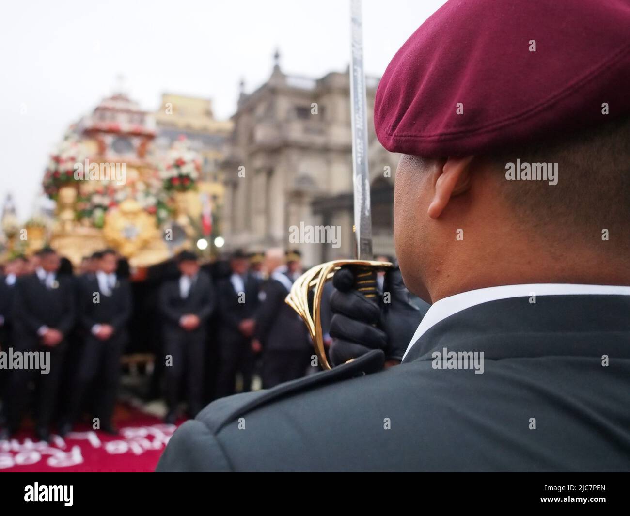 A police officer salutes the religious litter of Saint Rose of Lima ...