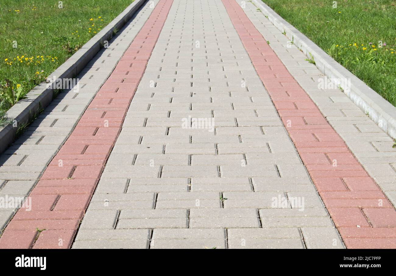 Brick path or sidewalk with perspective going into the distance with ...