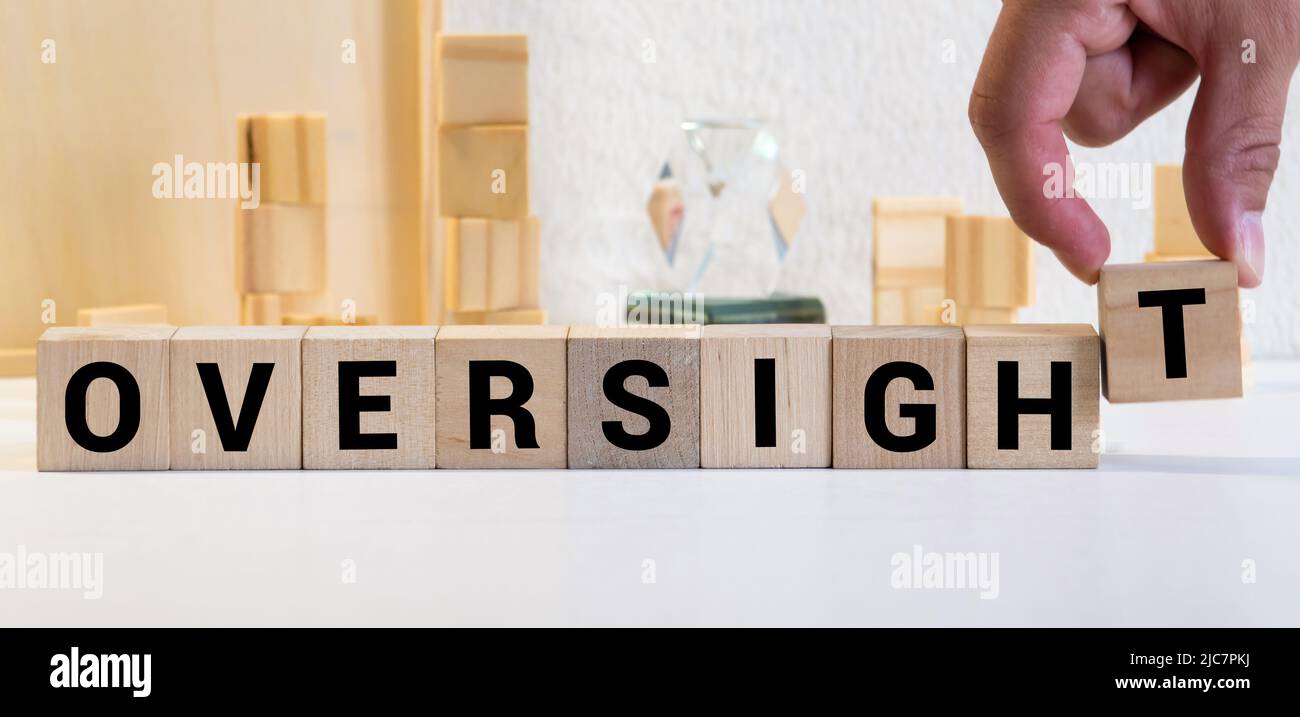 word Oversight on wooden block Stock Photo - Alamy