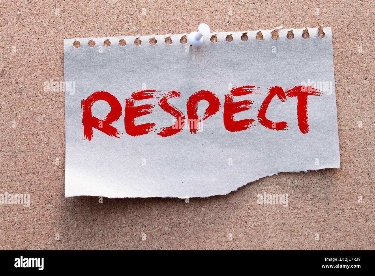 The word Respect in cut out magazine letters pinned to a cork notice ...