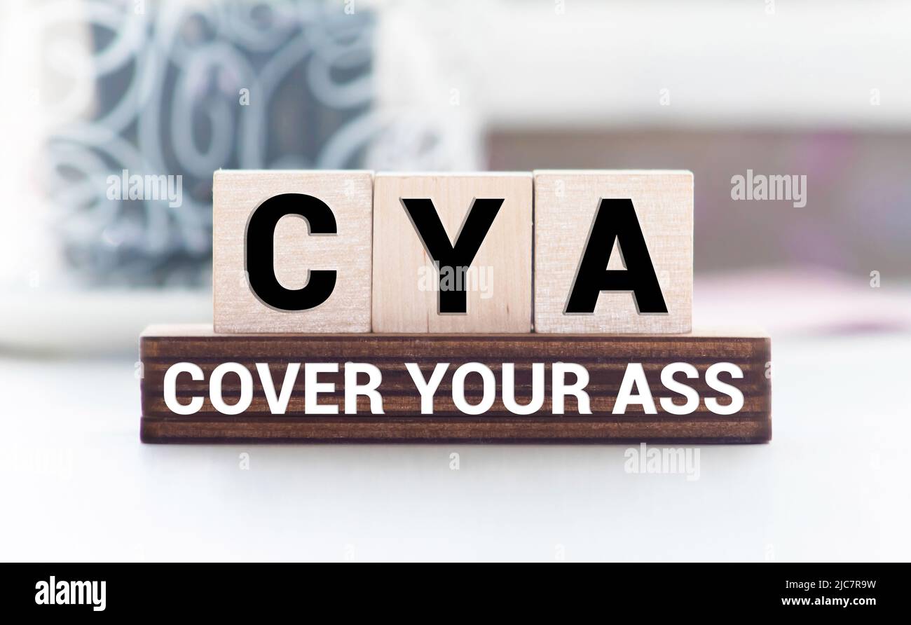 text cover your ass - CYA on wooden block Stock Photo - Alamy