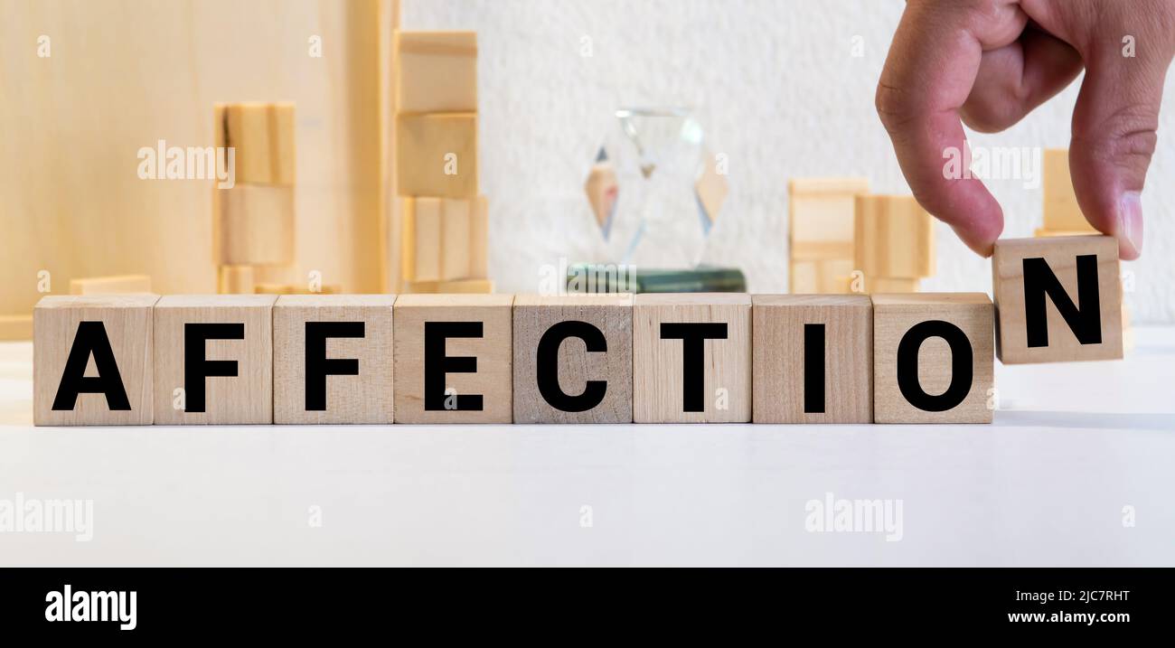Word AFFECTION is made of wooden building blocks lying on the table and ...