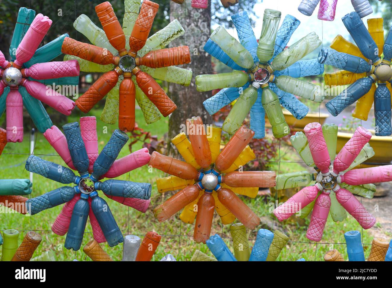 Flower shaped colourful decorations made of plastic bottles Stock Photo ...