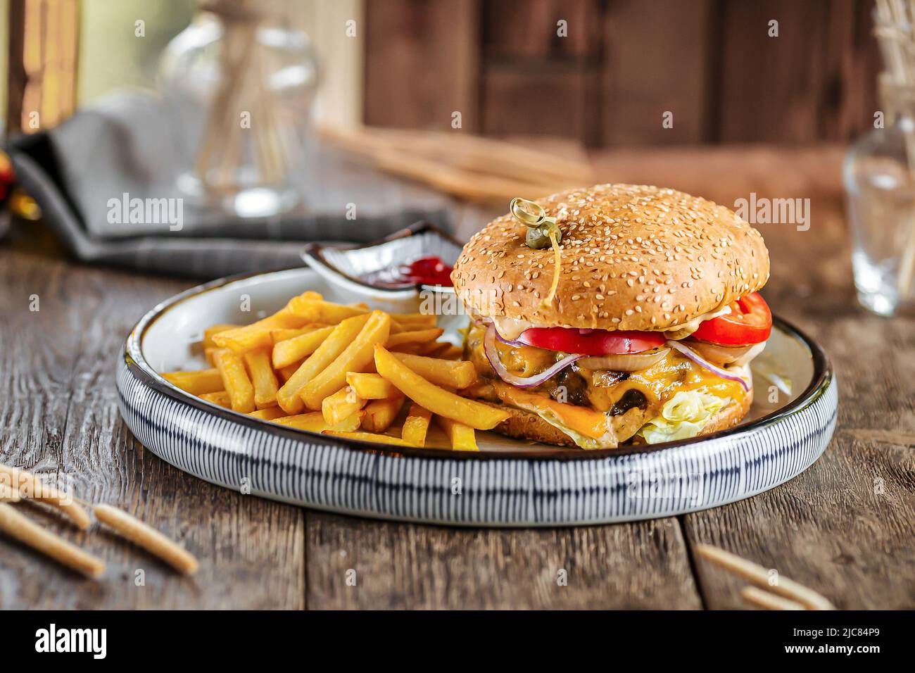 Gourmet portion of burger set with fries Stock Photo - Alamy