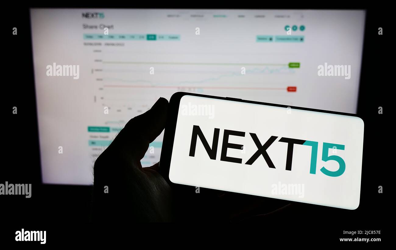 Person holding mobile phone with logo of company Next Fifteen ...