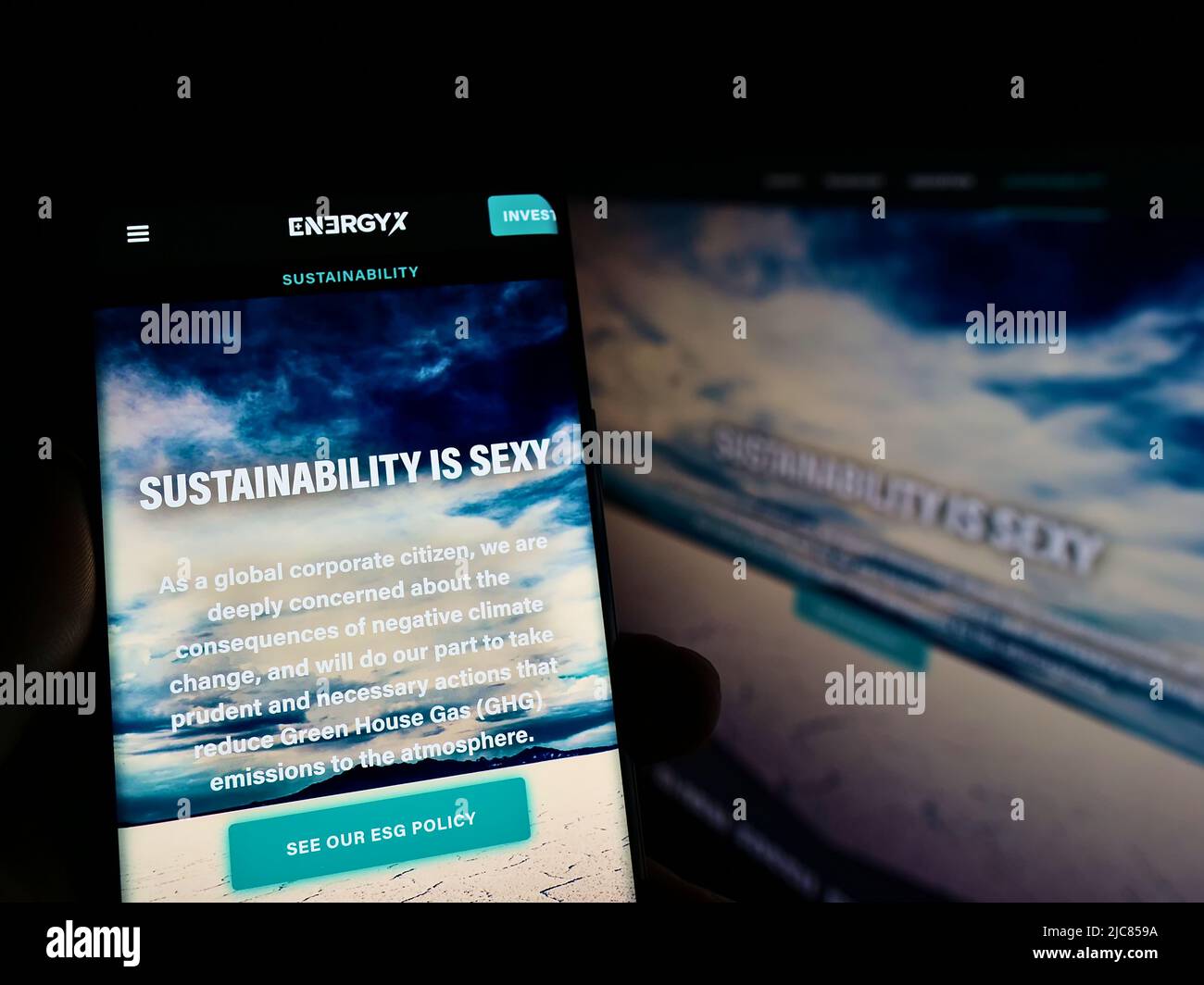 Person holding cellphone with website and logo of Energy Exploration ...