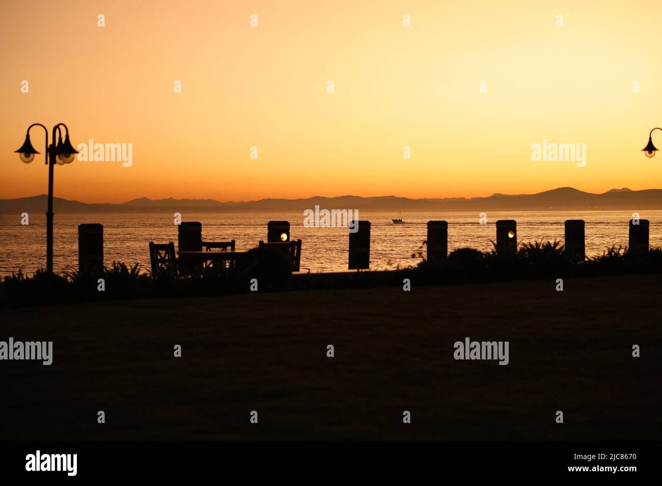 Cape Town sunset ocean view, VA Waterfront, Houts Bay, yellow sky and ...