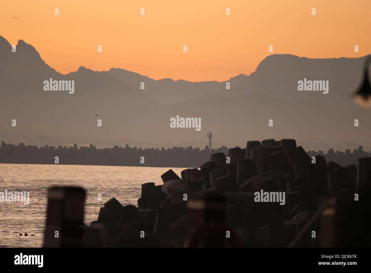 Cape Town sunset ocean view, VA Waterfront, Houts Bay, yellow sky and ...