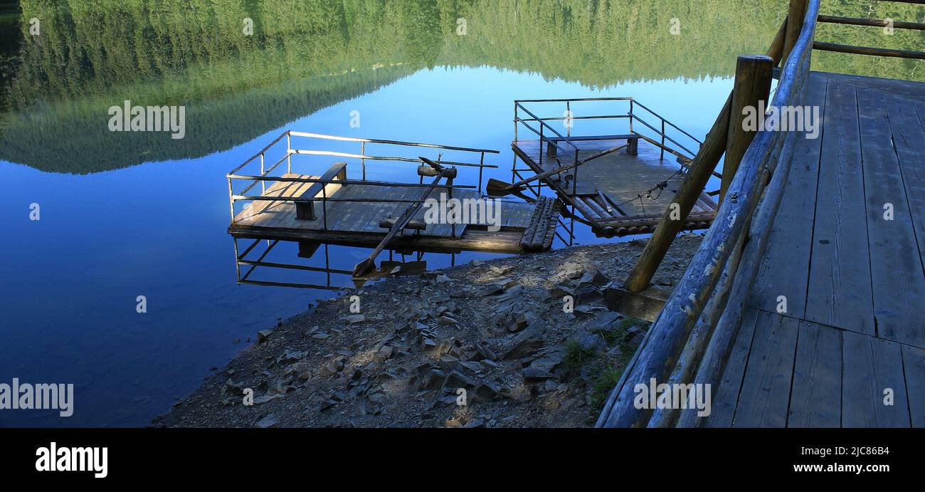 Calm Surface Of Lake Water With Old Raft Near Wooden Berth Stock Photo ...