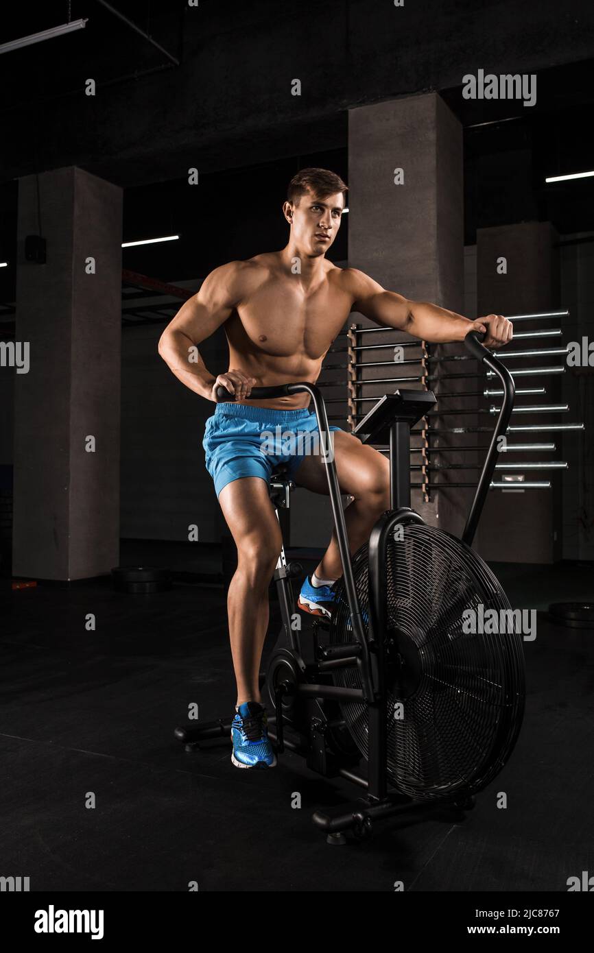 Athlete man biking in the gym Stock Photo - Alamy