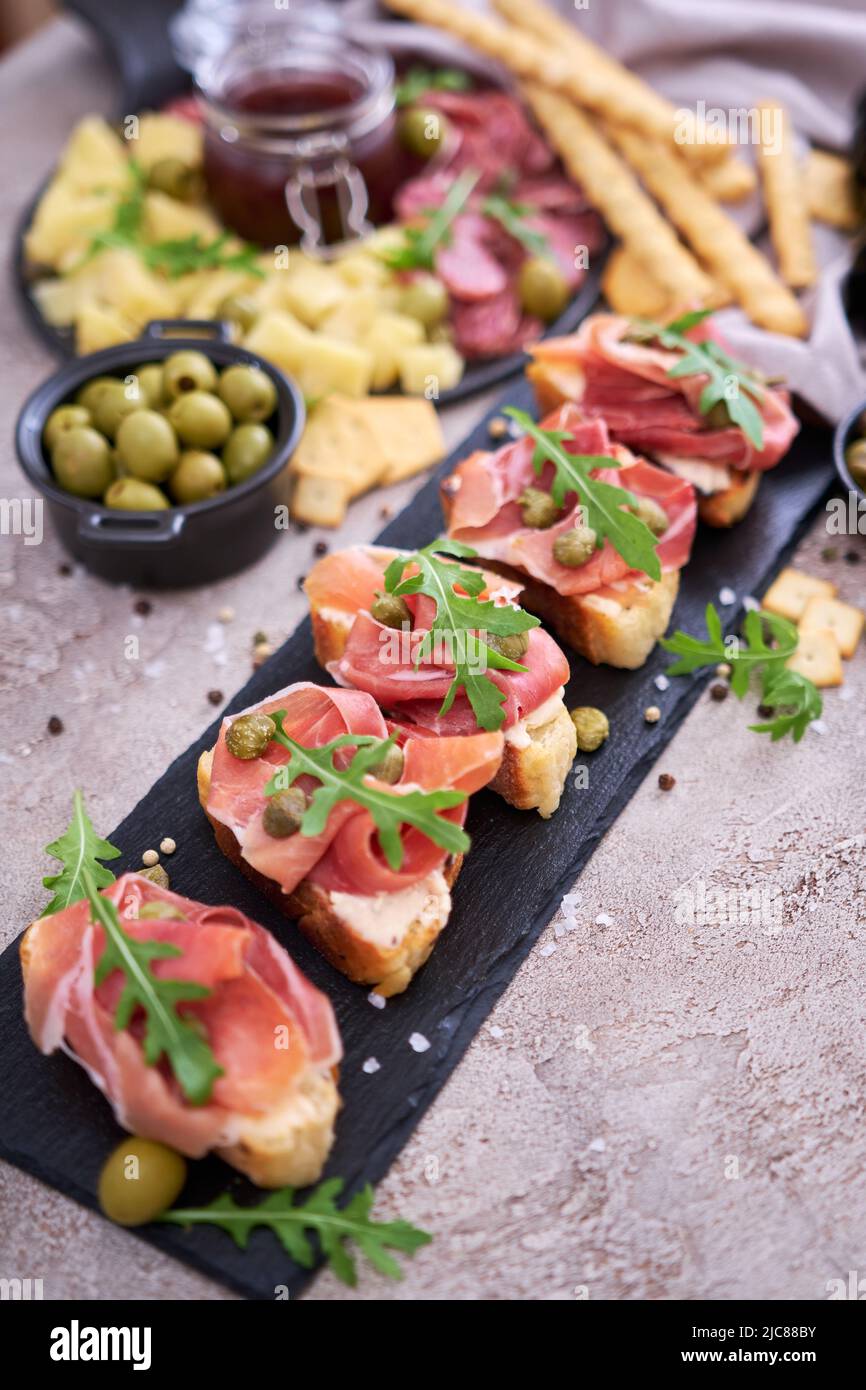 bruschetta with prosciutto ham and capers with traditional antipasto ...