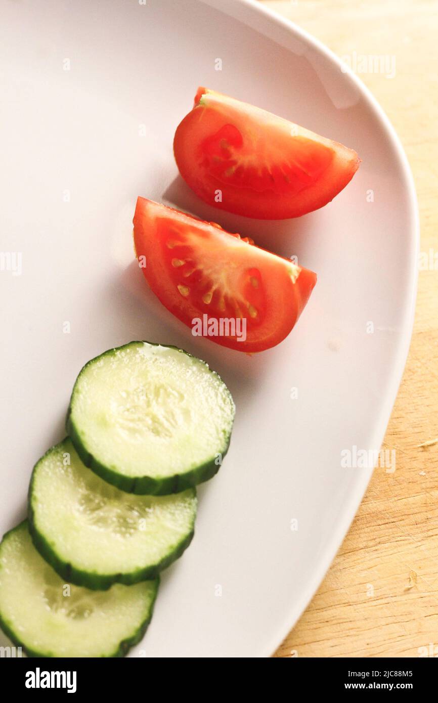 Tomato wedges and cucumber slices Stock Photo - Alamy
