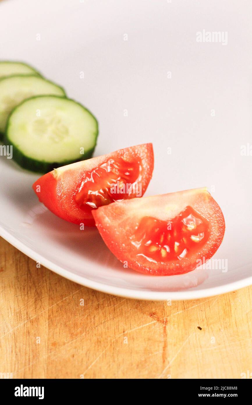 Tomato wedges and cucumber slices Stock Photo - Alamy