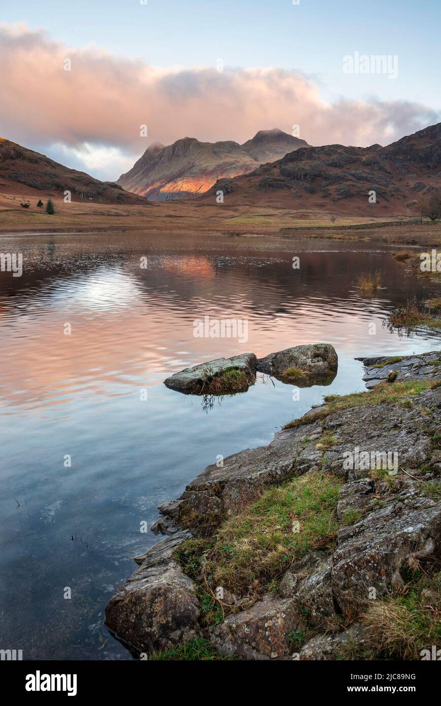 Epic landscape of sunrise light over Blea Tarn in Lake District with ...