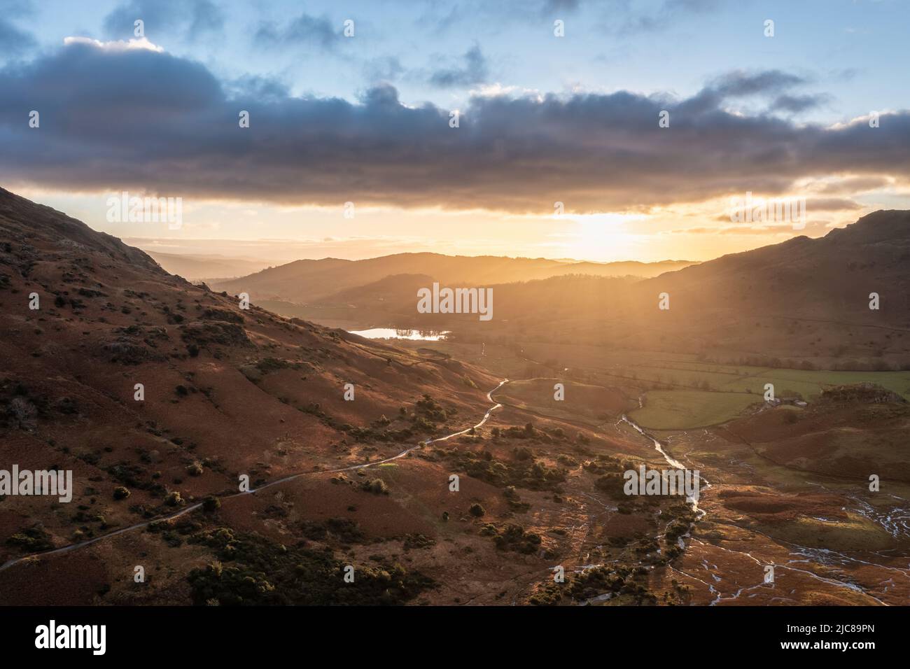 Epic aerial drone landscape image of sunrise from Blea Tarn in Lake ...