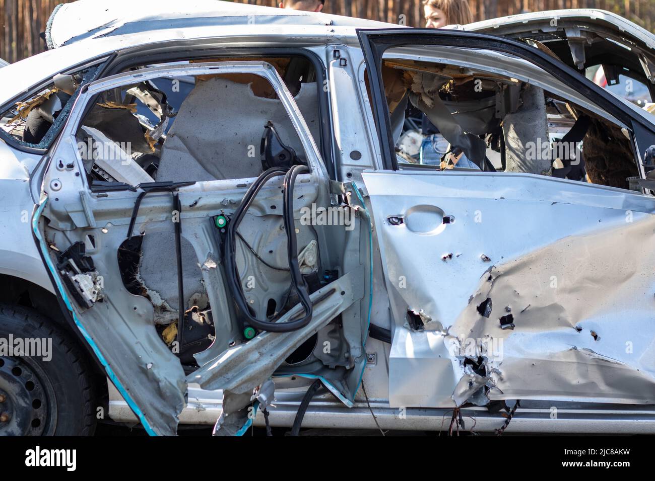 A warped, flattened car after an accident, after a strong side impact ...