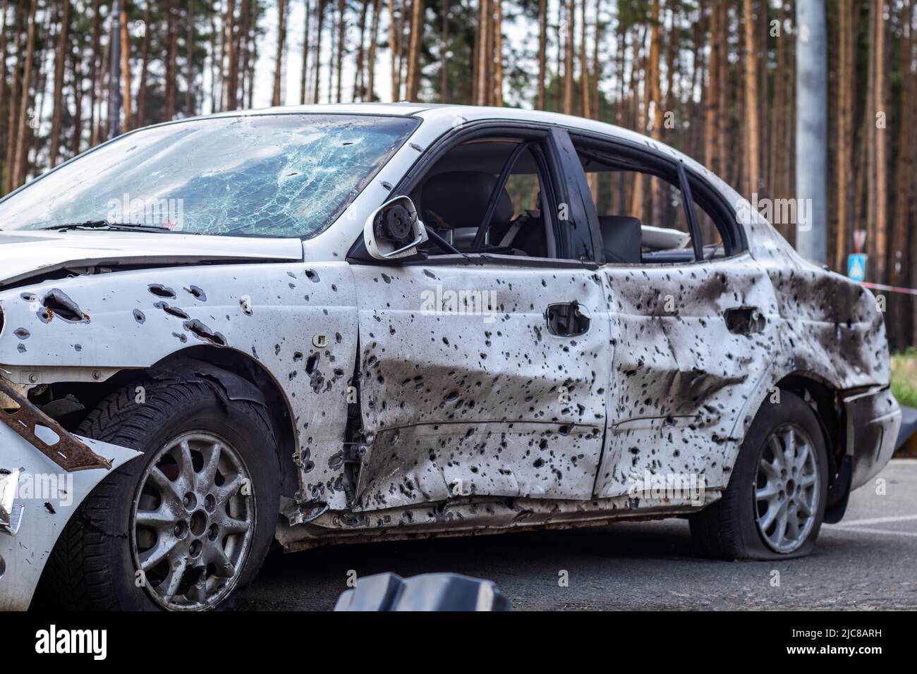 Shot, damaged cars during the war in Ukraine. The vehicle of civilians ...