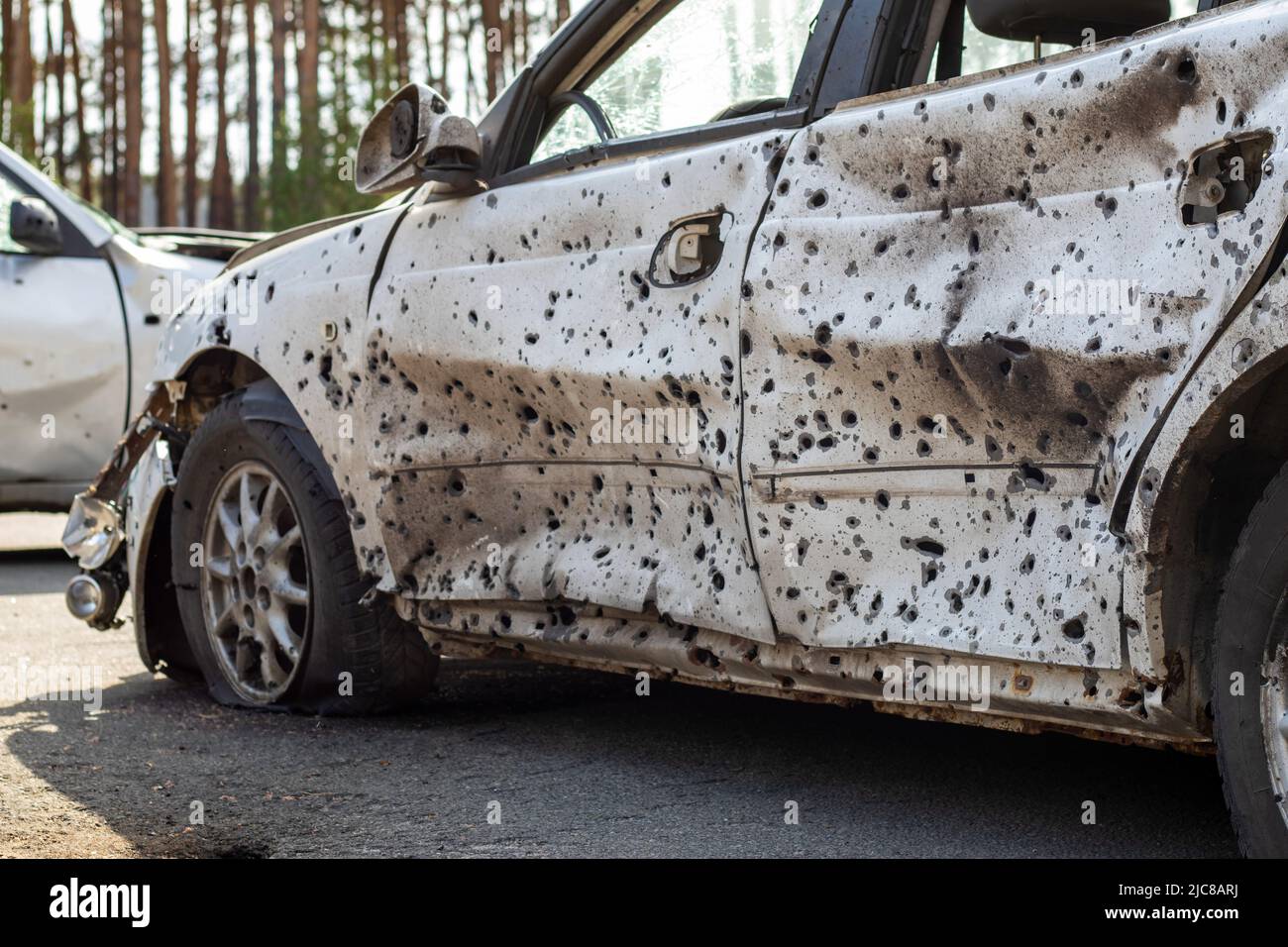 A car destroyed by shrapnel from a rocket that exploded nearby ...