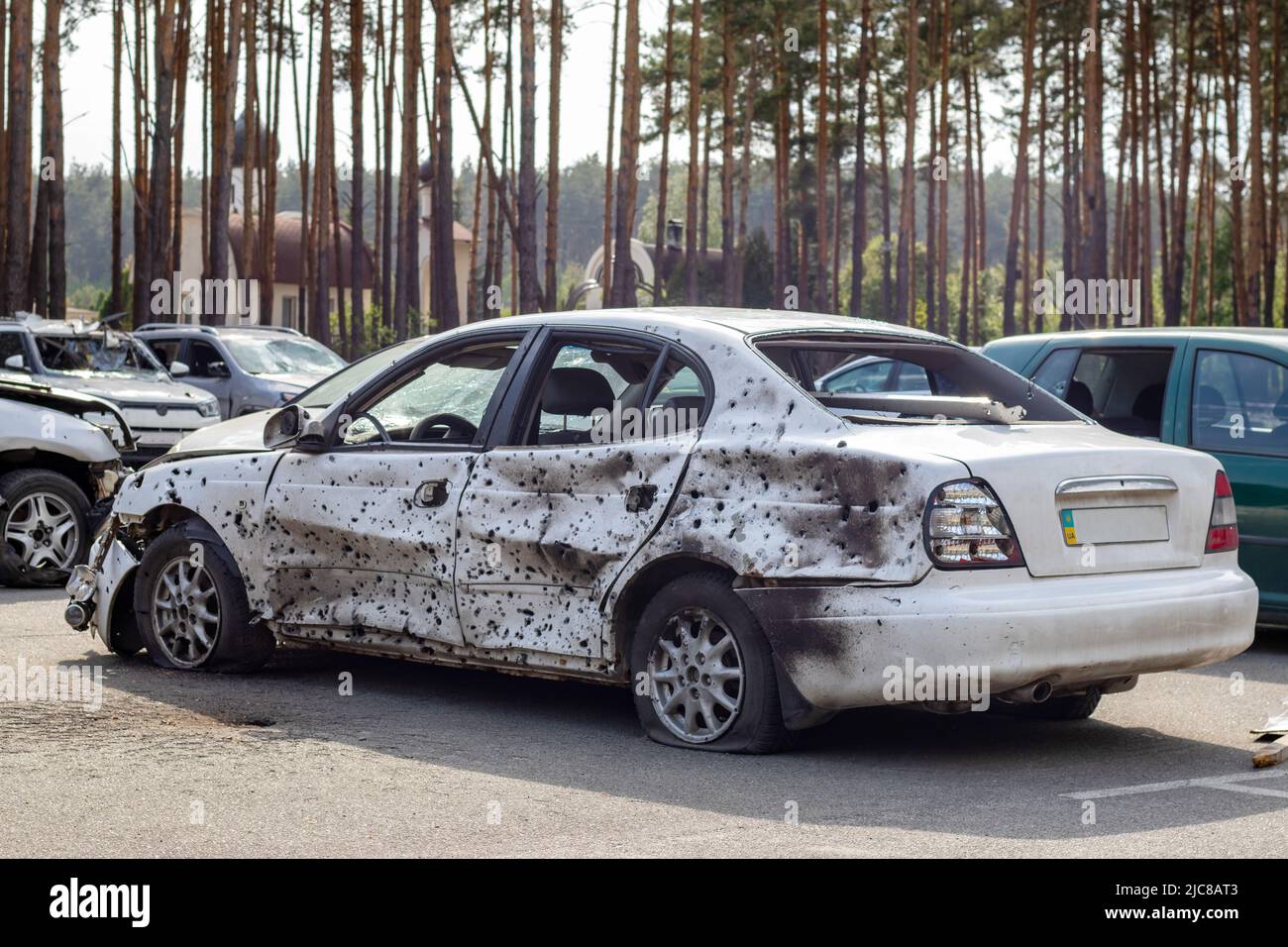 A car destroyed by shrapnel from a rocket that exploded nearby ...