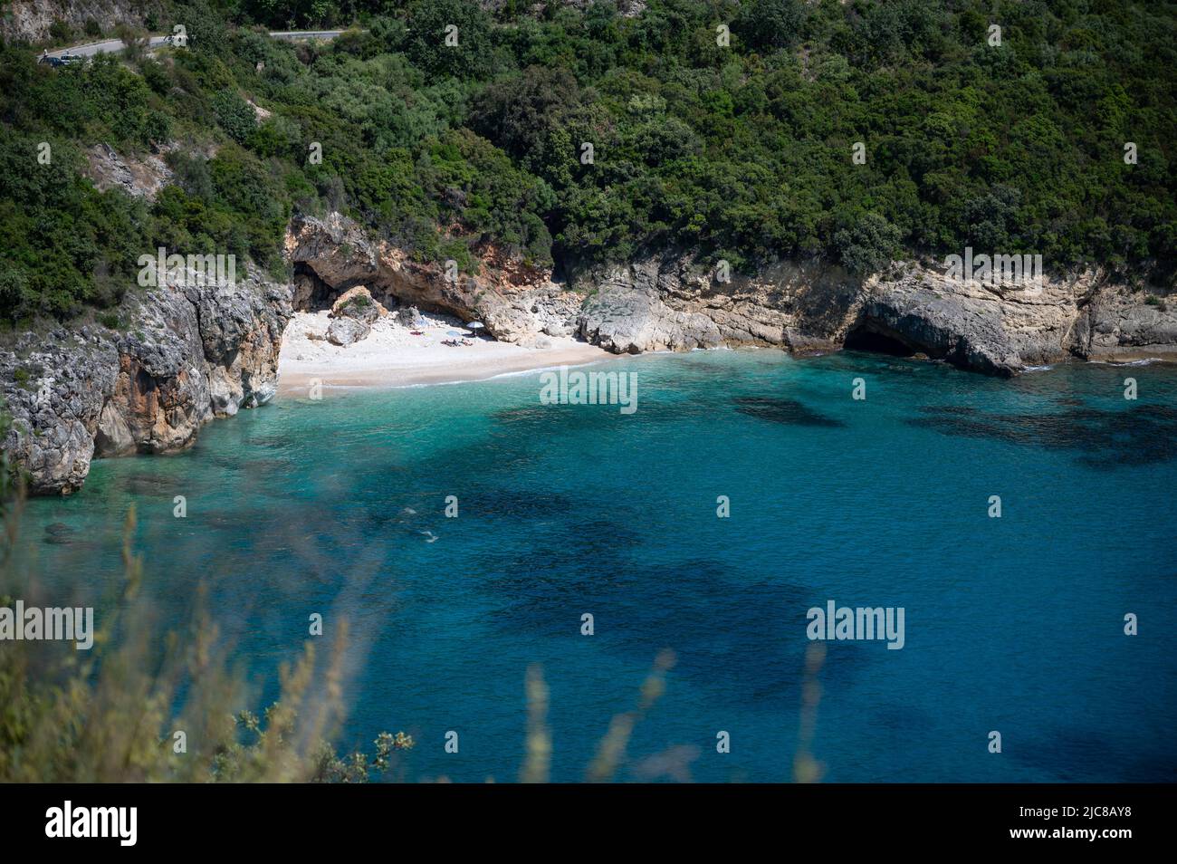 Greek beach with blue water and warm sand Stock Photo - Alamy