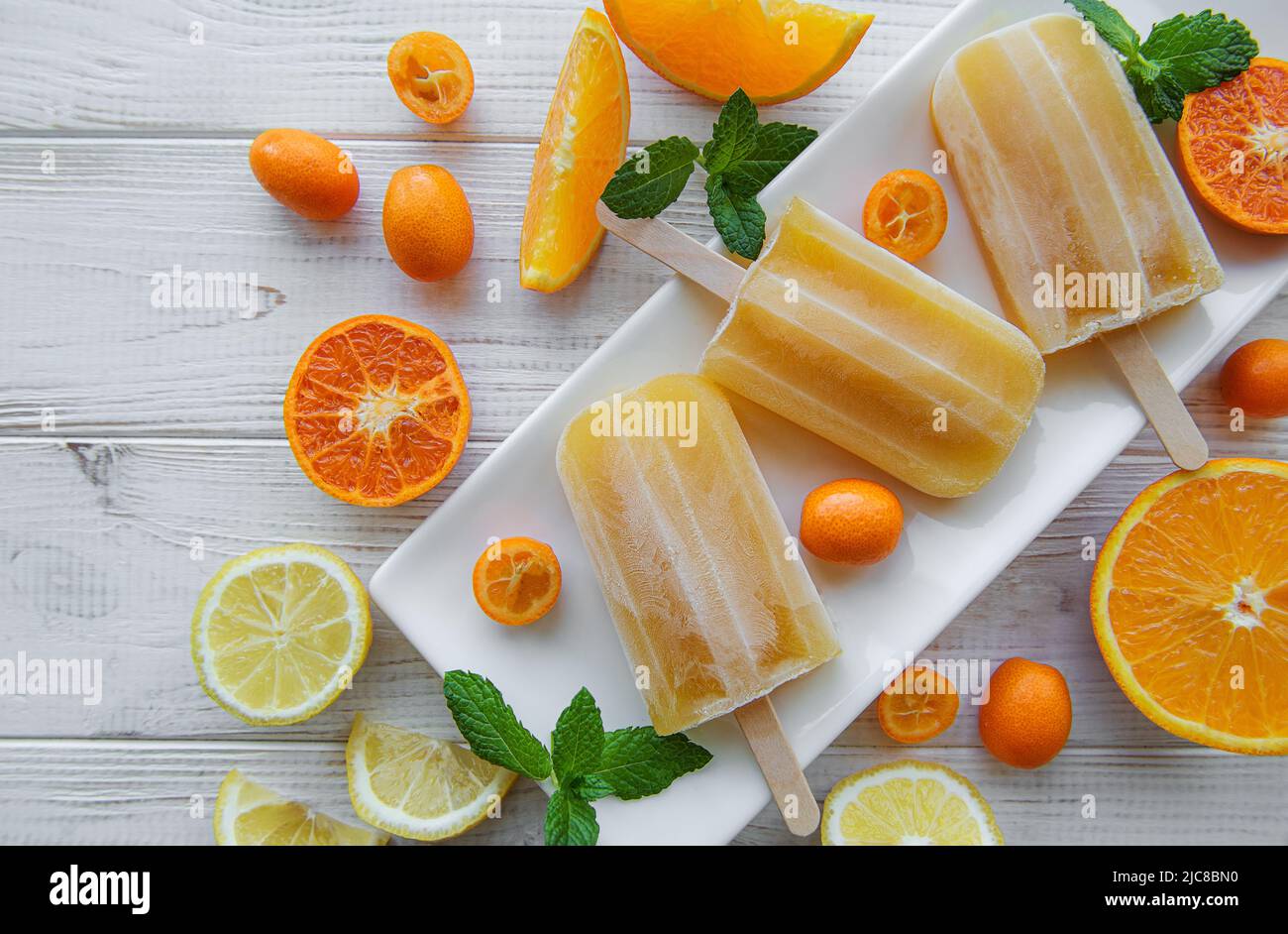 Fruit orange ice popsicle, ice cubes and slices of citrus fruits Stock ...