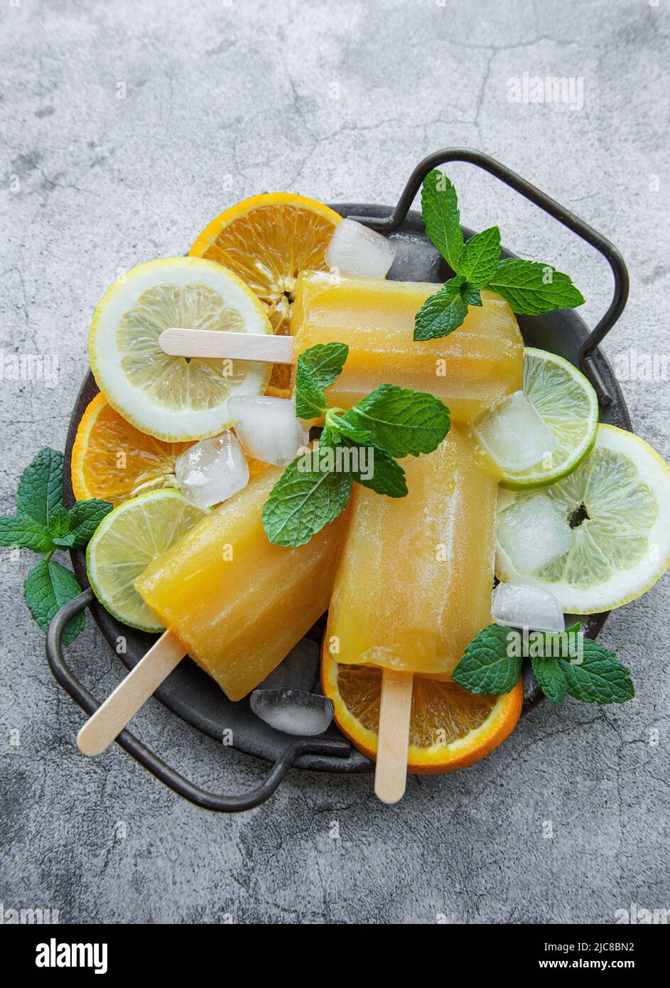 Fruit orange ice popsicle, ice cubes and slices of citrus fruits Stock ...