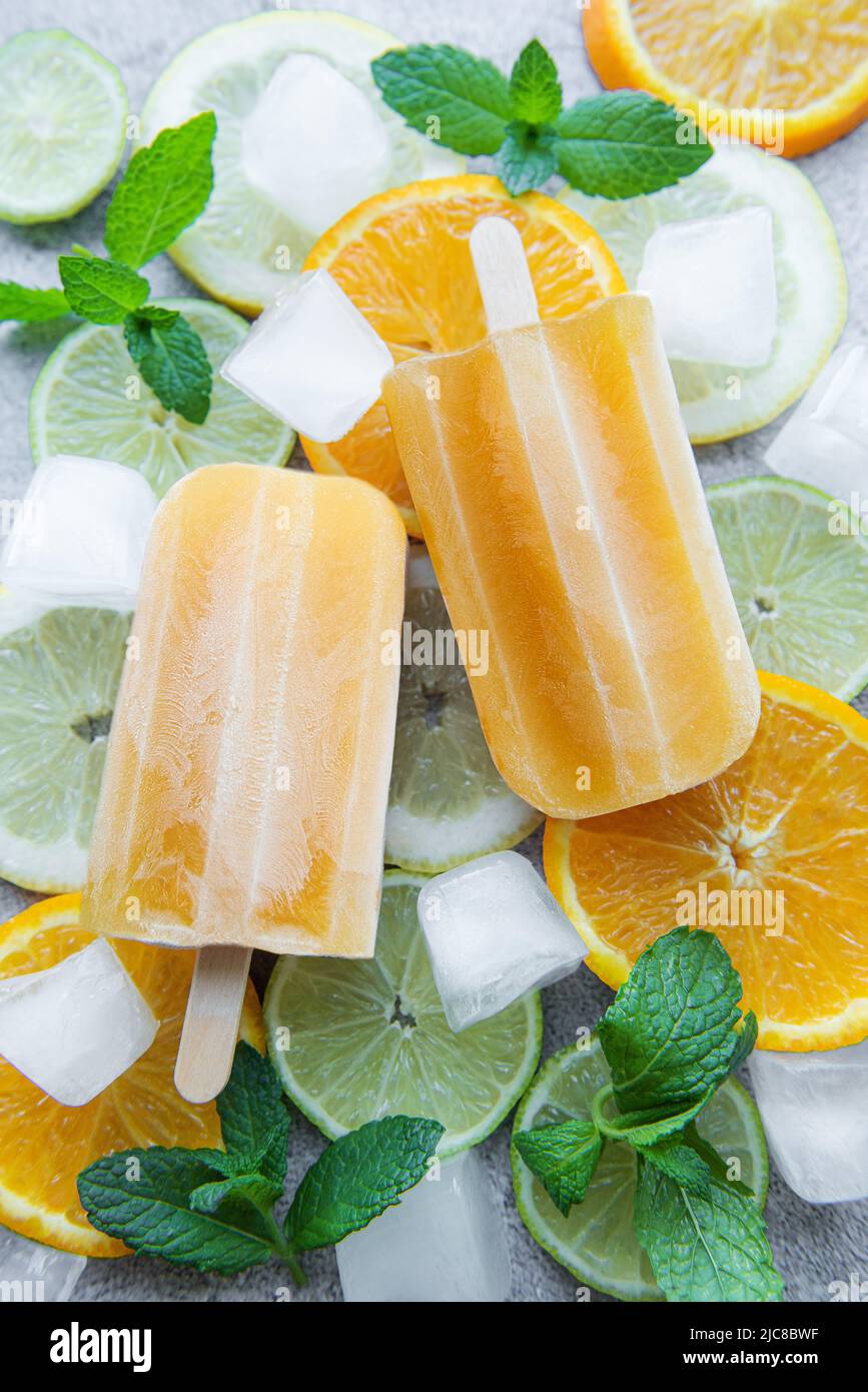 Fruit orange ice popsicle, ice cubes and slices of citrus fruits Stock ...